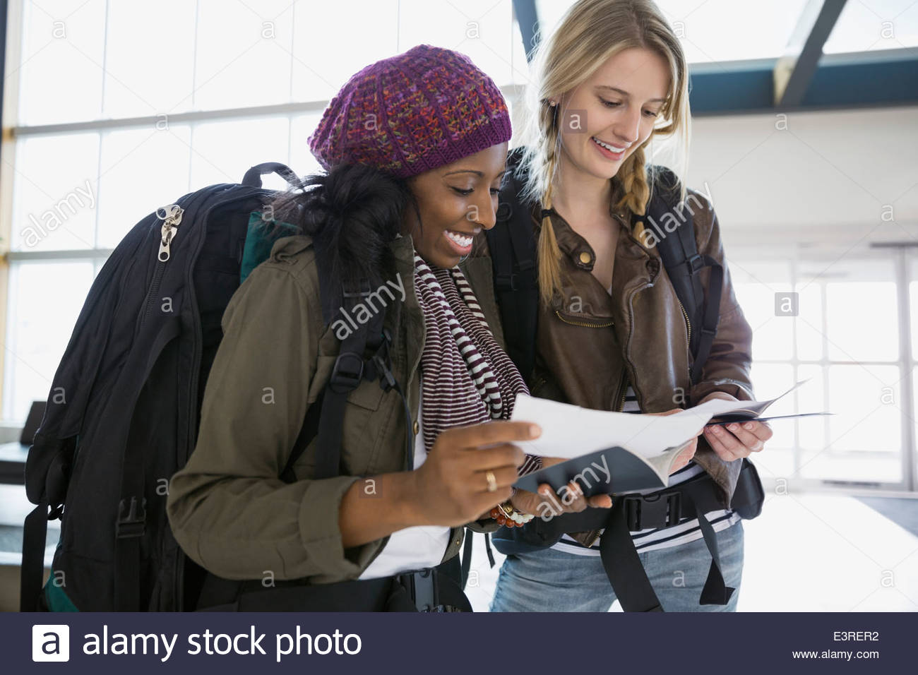 Women looking at tickets in airport Stock Photo - Alamy