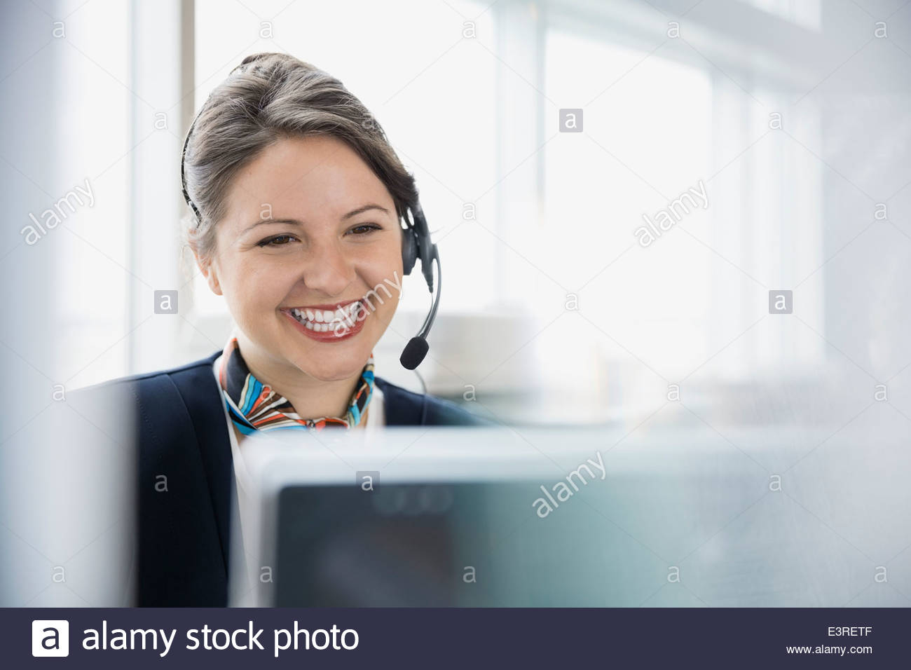 Airport customer service representative with headset at computer Stock ...