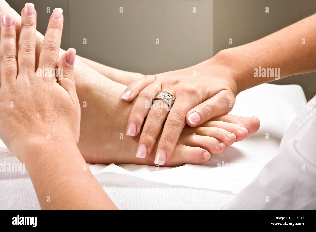 Woman's hands giving a healthy foot massage Stock Photo - Alamy