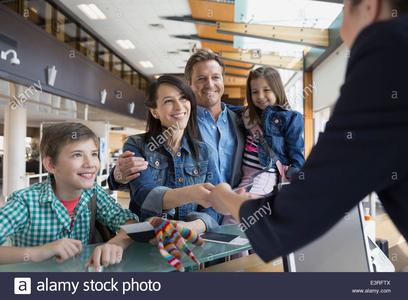 Family checking in hi-res stock photography and images - Alamy