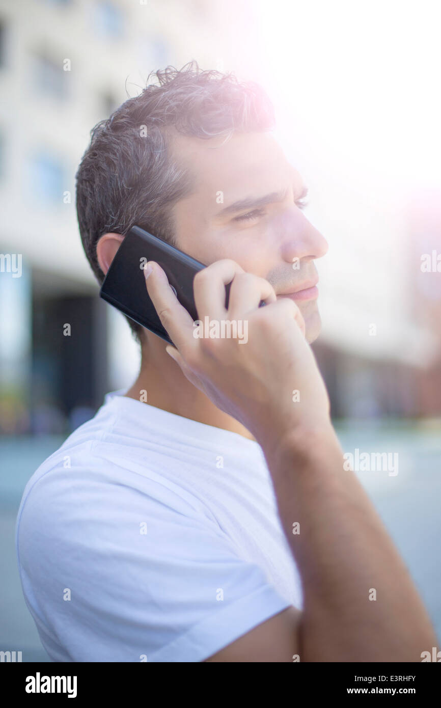 Young man talking on mobile phone Stock Photo - Alamy