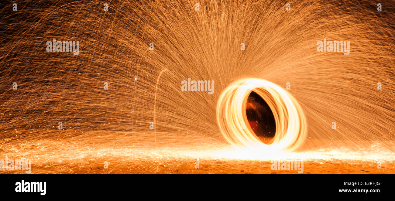 Circle spark from man spin burning steelwool Stock Photo - Alamy