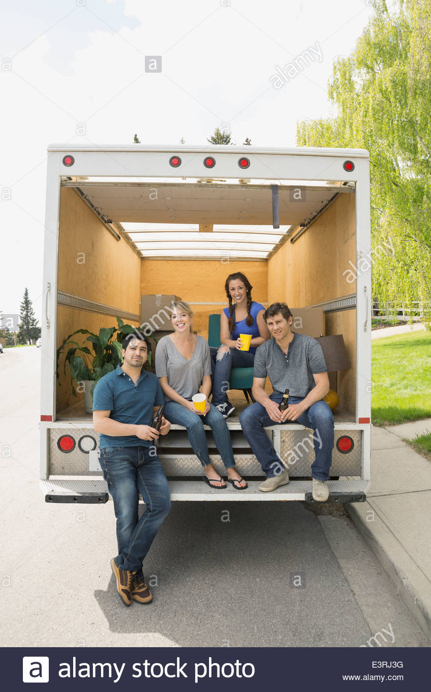 Portrait of couples at back of moving van Stock Photo - Alamy