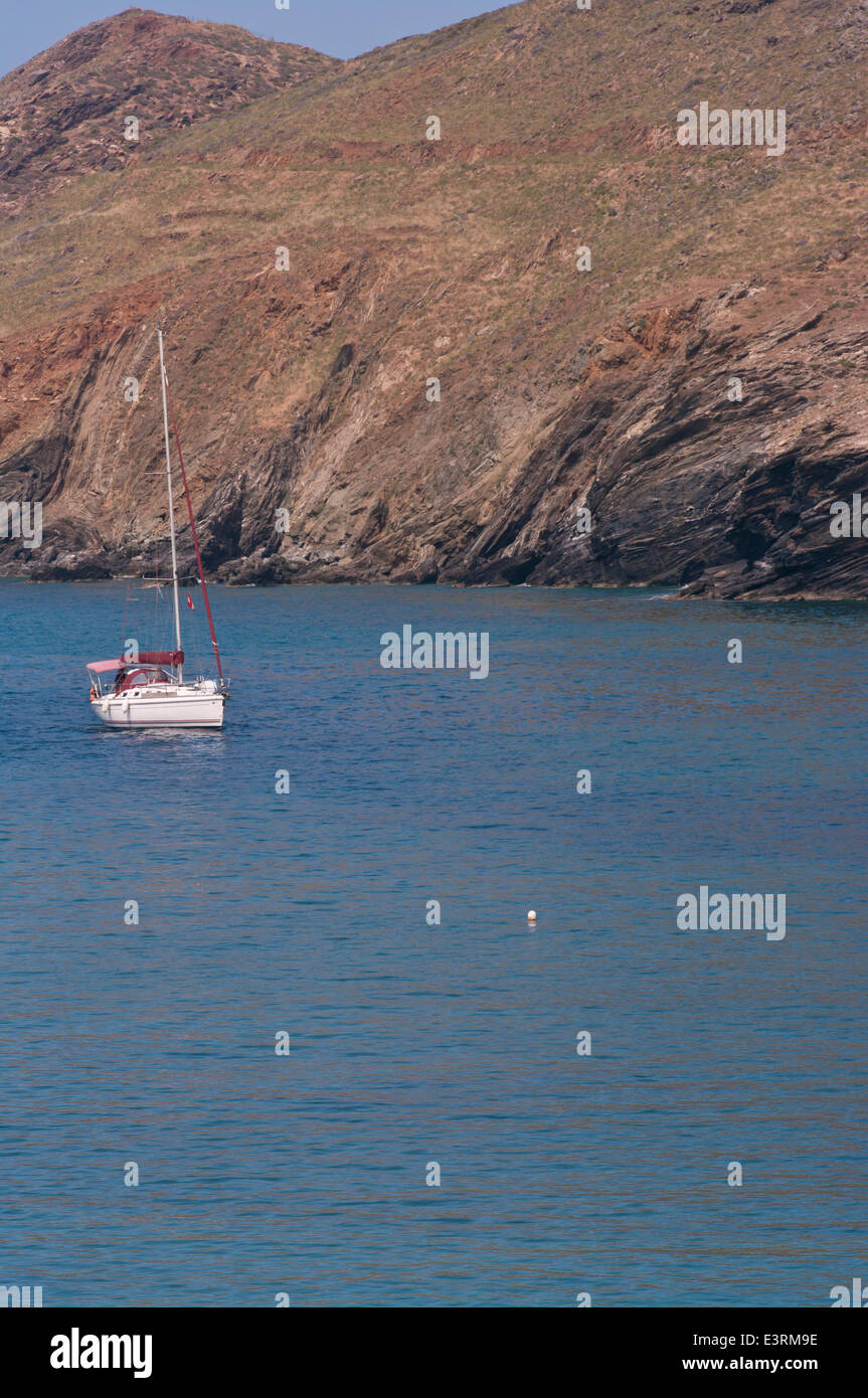 Yacht With Sails Down On Blue Calm Sea Stock Photo - Alamy