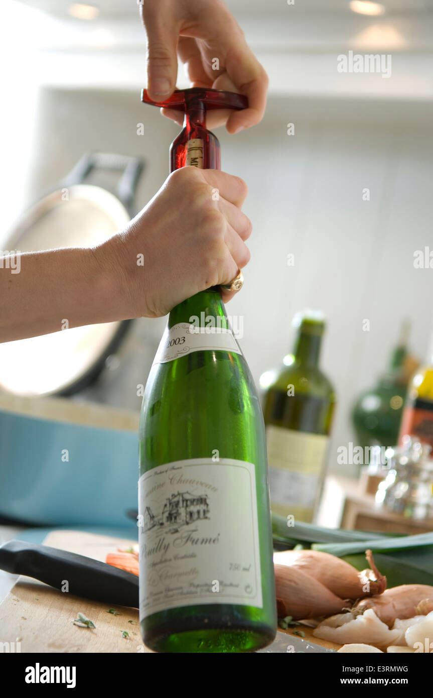 Pulling cork from wine bottle in kitchen Stock Photo - Alamy
