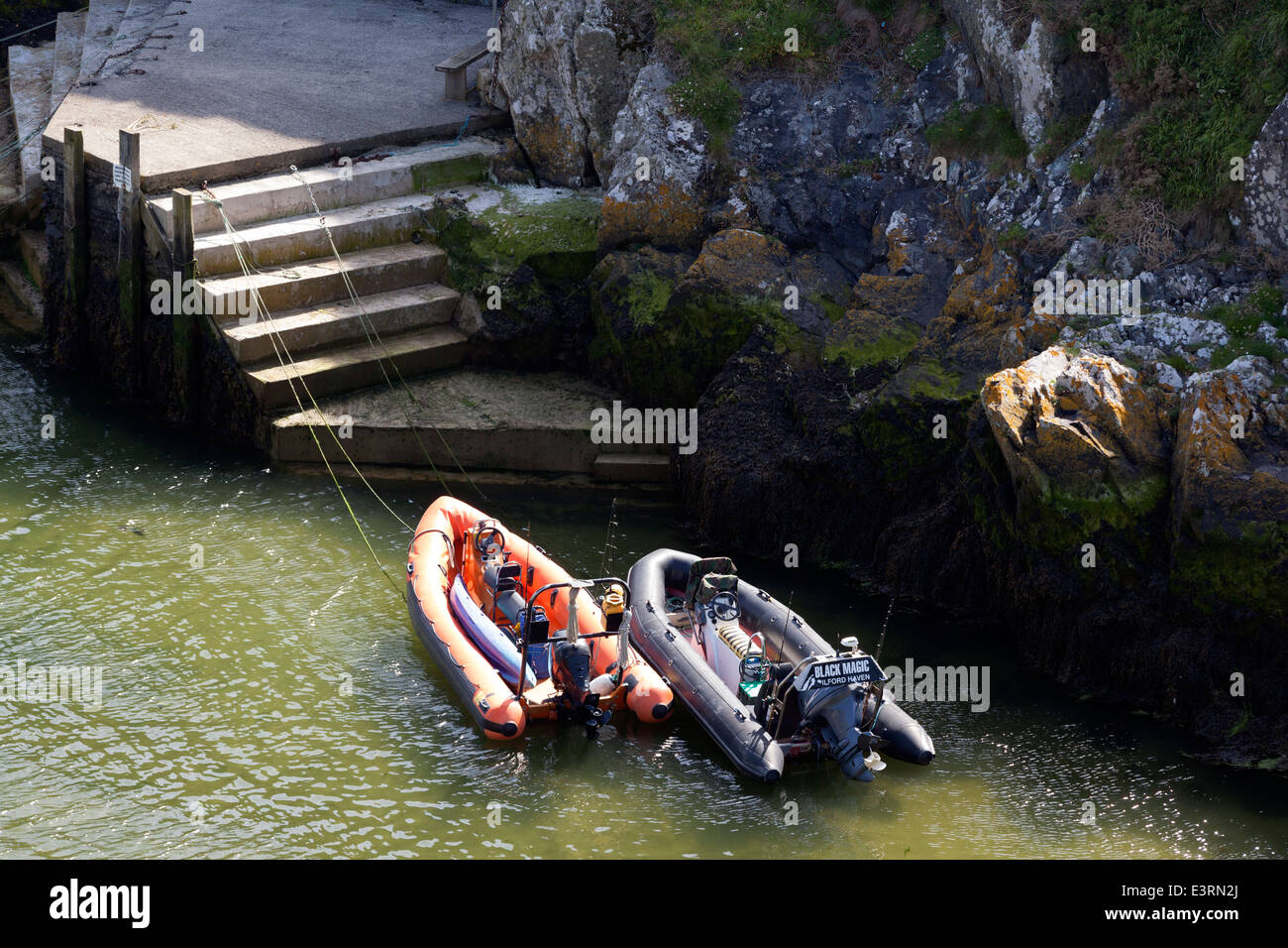 Inflatables tied up alongside steps in the harbour, Porthclais ...