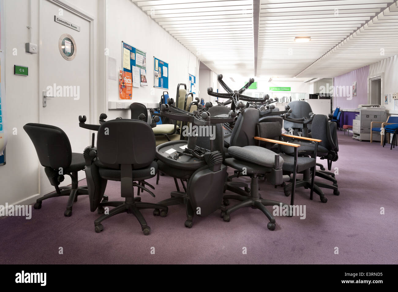 new build or closure of offices computer chairs stacked piled up ...