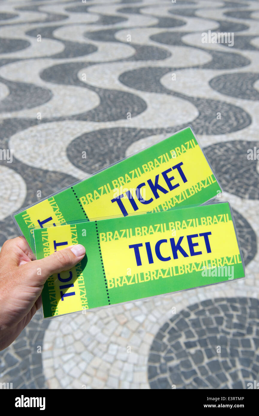 Hand holding two Brazil tickets at the Copacabana Rio de Janeiro ...