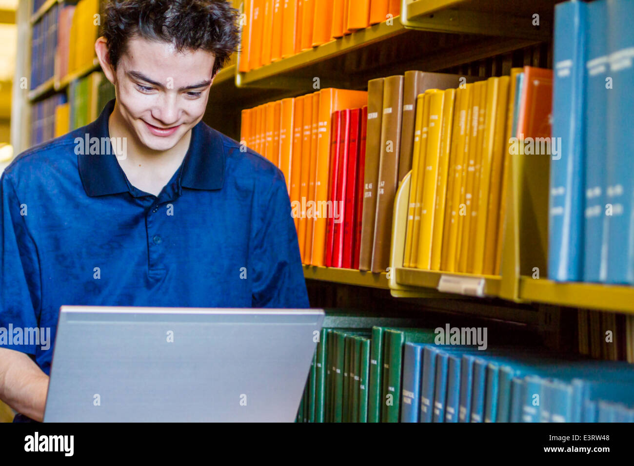 College student with laptop in campus library Stock Photo - Alamy