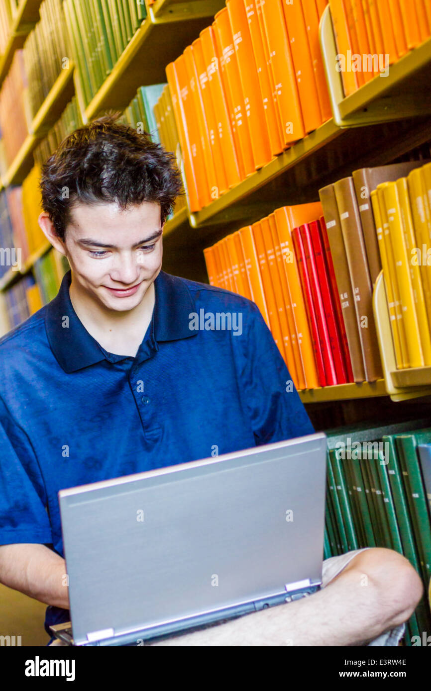 College student with laptop in campus library Stock Photo - Alamy