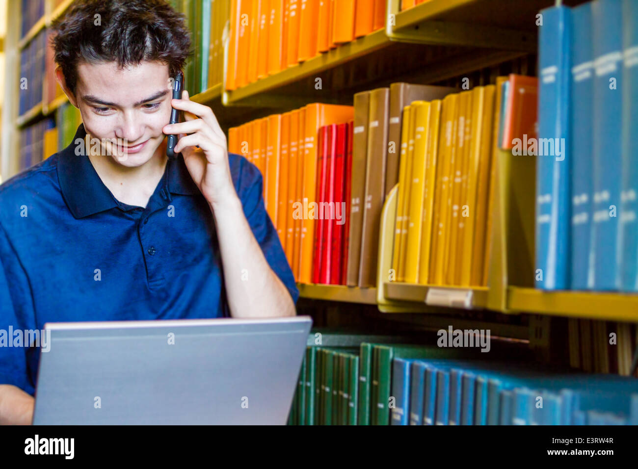 College student with laptop in campus library Stock Photo - Alamy