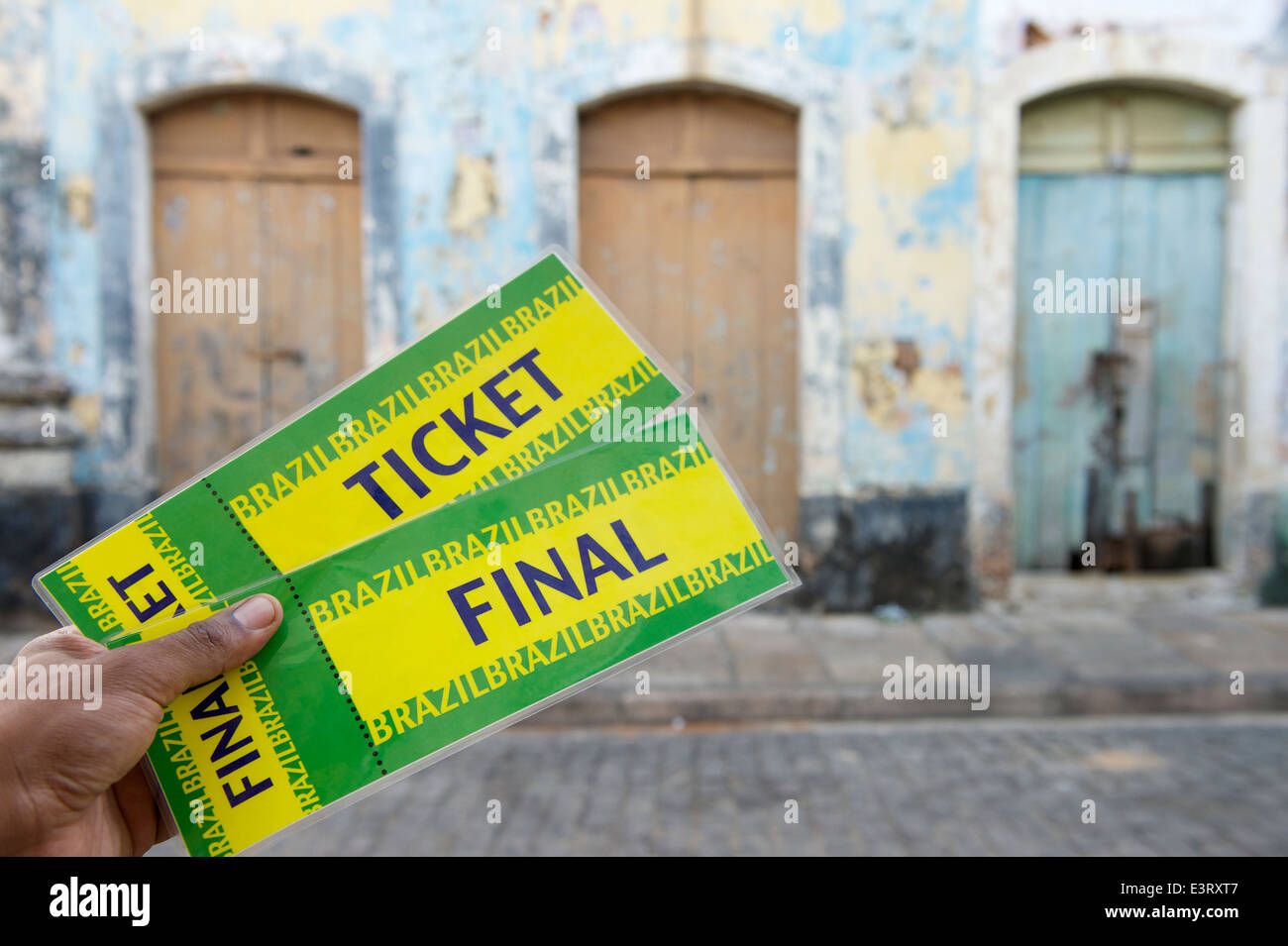 Brazilian hand holding two final tickets outdoors on traditional ...