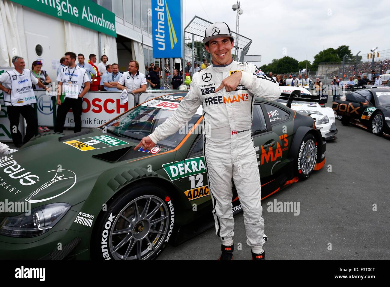 HANDOUT - The Canadian DTM pilot Robert Wickens stands next to his ...