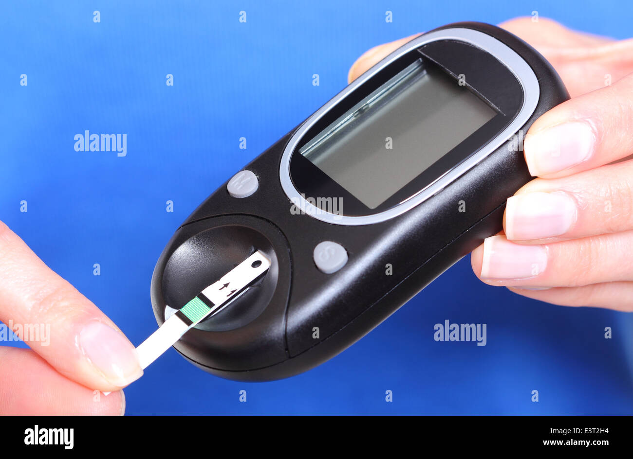 Closeup of strip for glucose testing and glucometer, measuring sugar ...