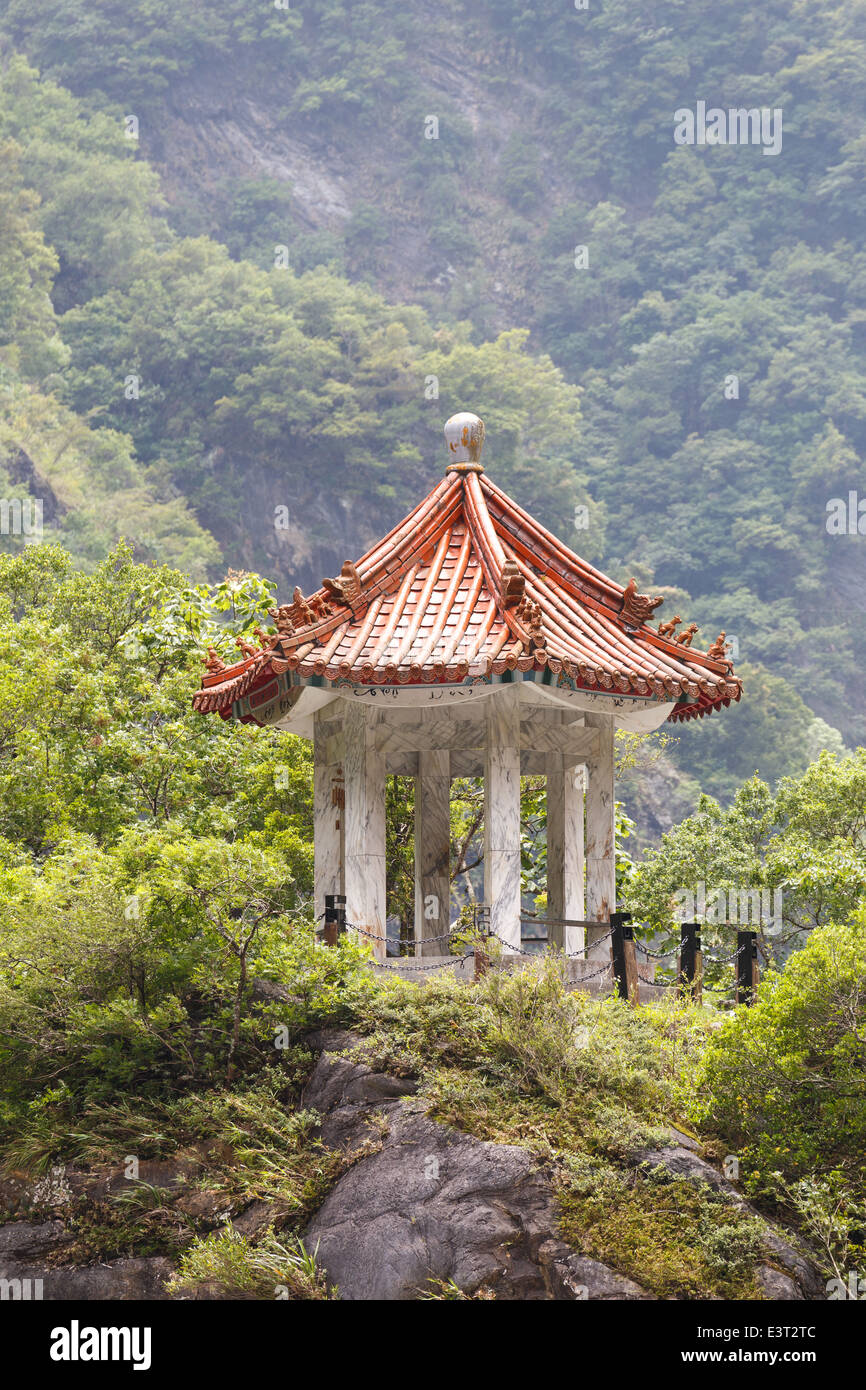 Small traditional Chinese pavillion perched atop a cliff in the ...