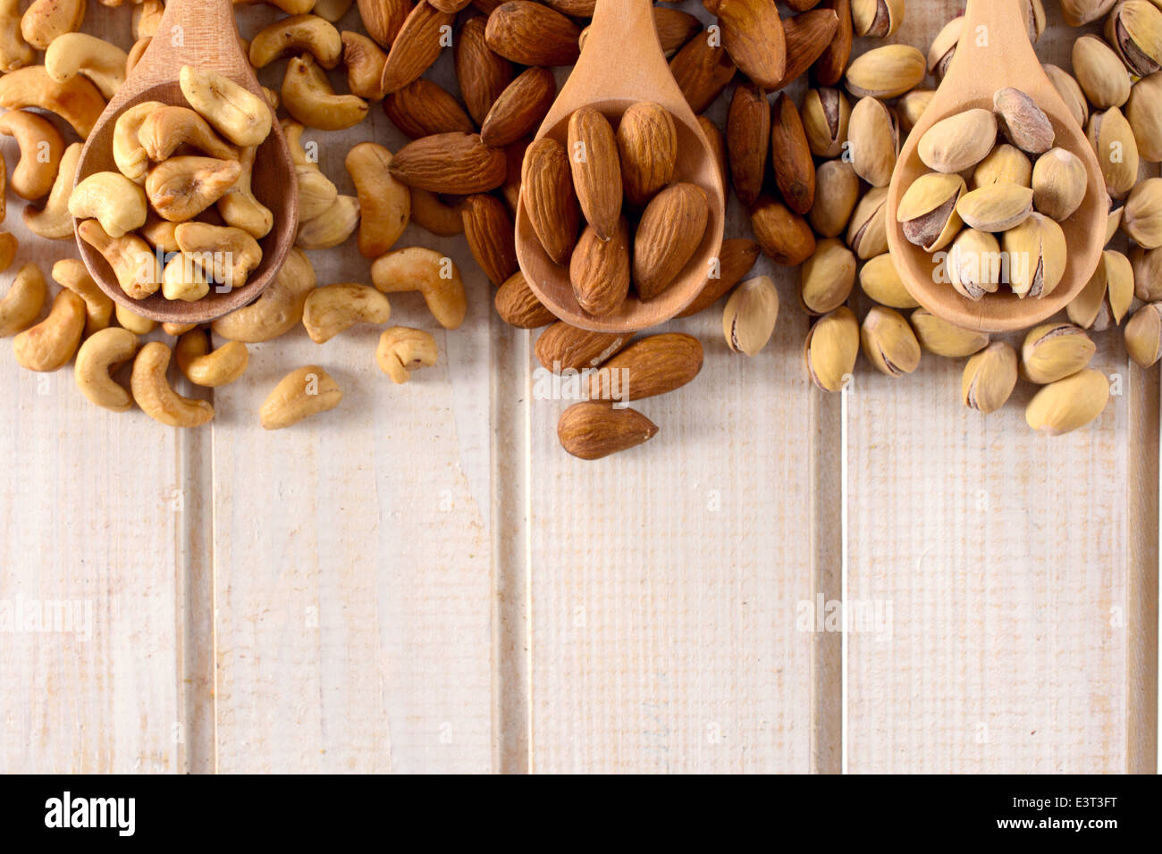 Nuts mix in the wooden ladles from above and blank space below Stock ...