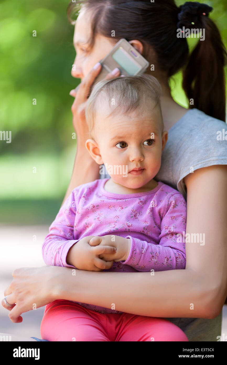 Baby girl in mothers arms Stock Photo - Alamy