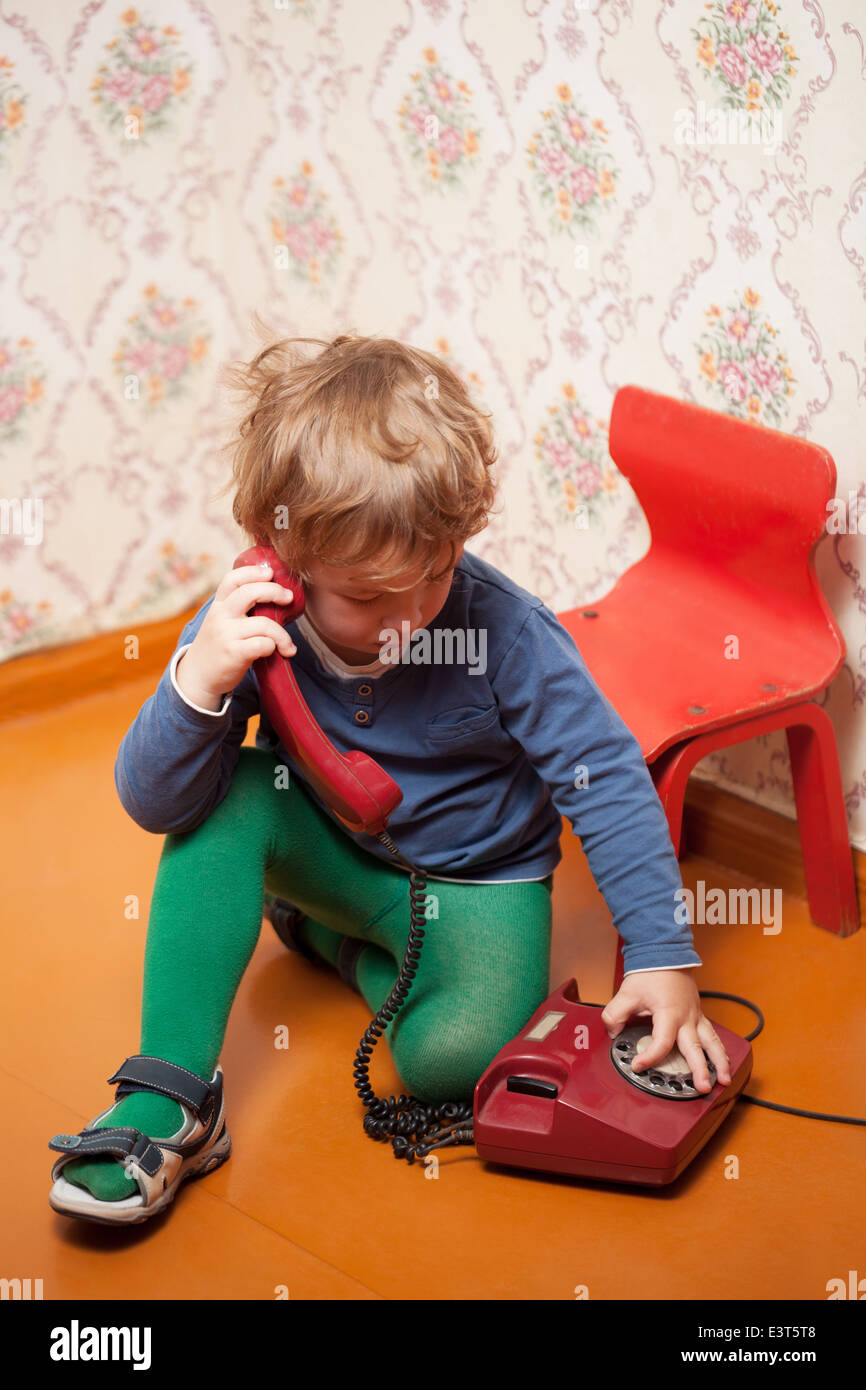 Young boy using red phone Stock Photo - Alamy