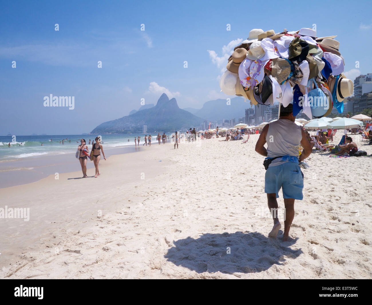 RIO DE JANEIRO, BRAZIL - MARCH 09, 2013: Beach vendor selling hats ...