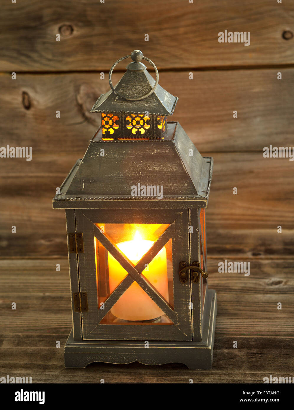 Vertical front view of an old Asian design lantern with white candle ...