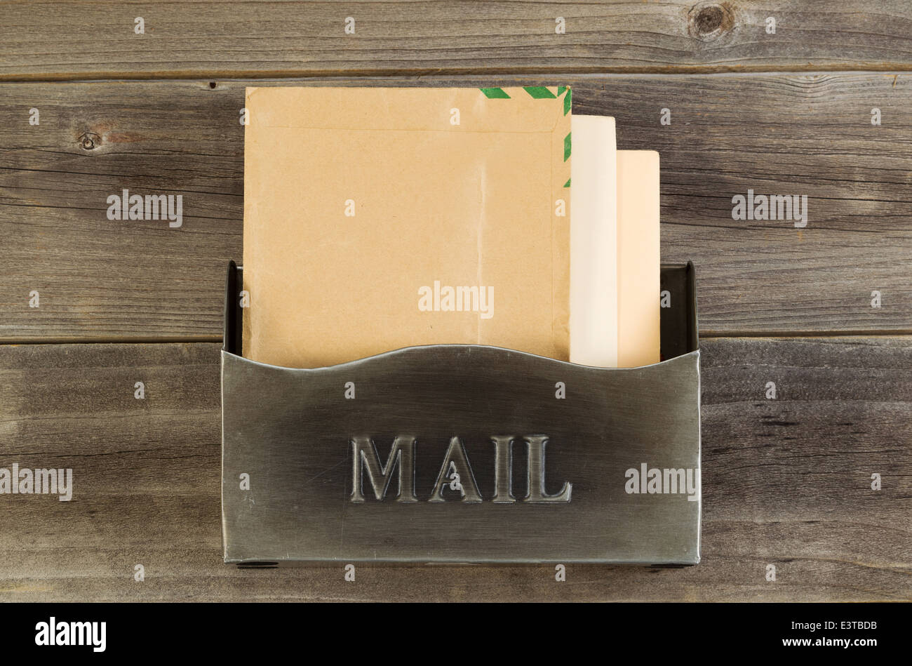 Overhead view of an old metal mailbox with letters inside on rustic ...