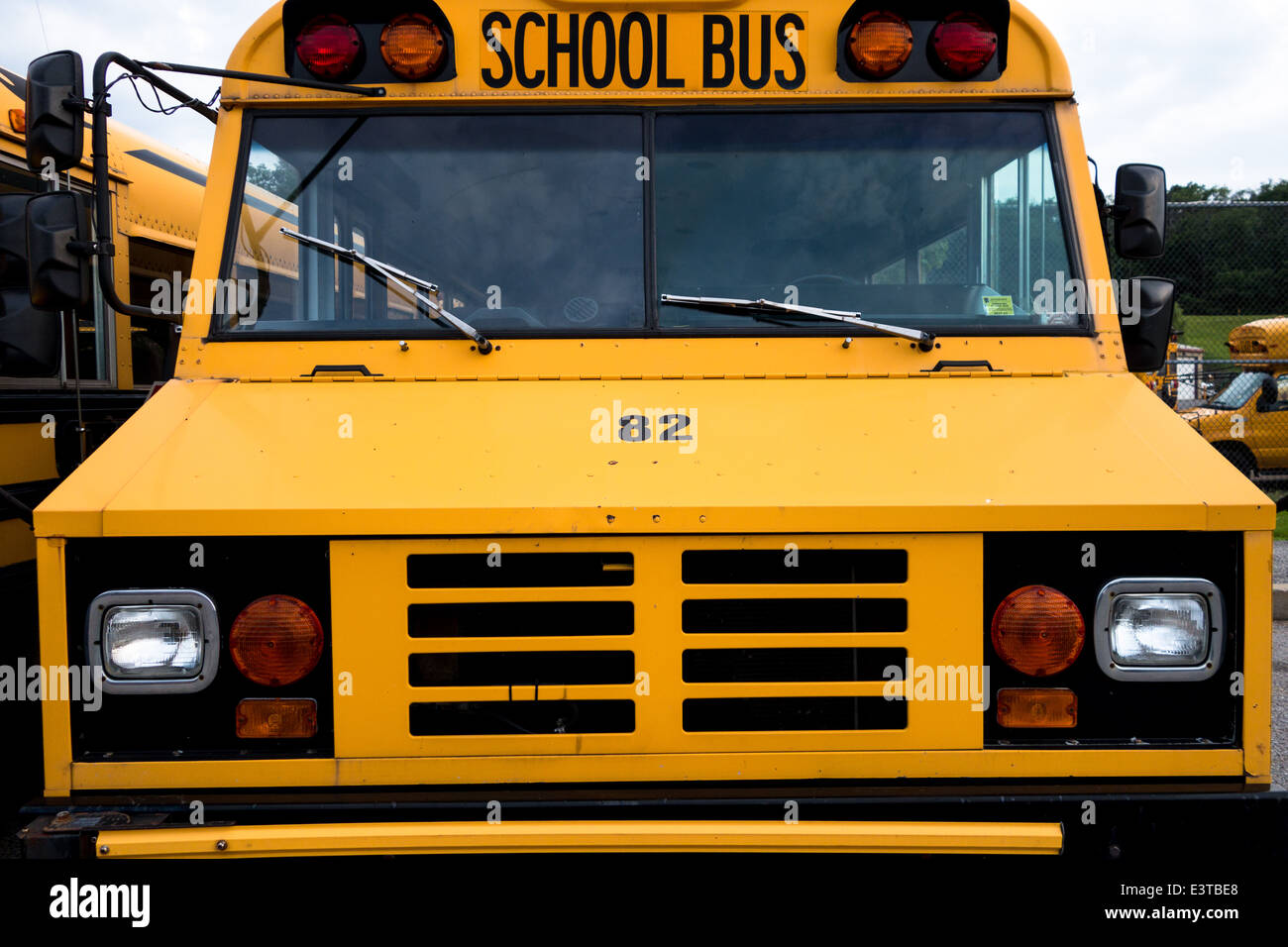 A yellow school bus in a bus parking lot Stock Photo - Alamy