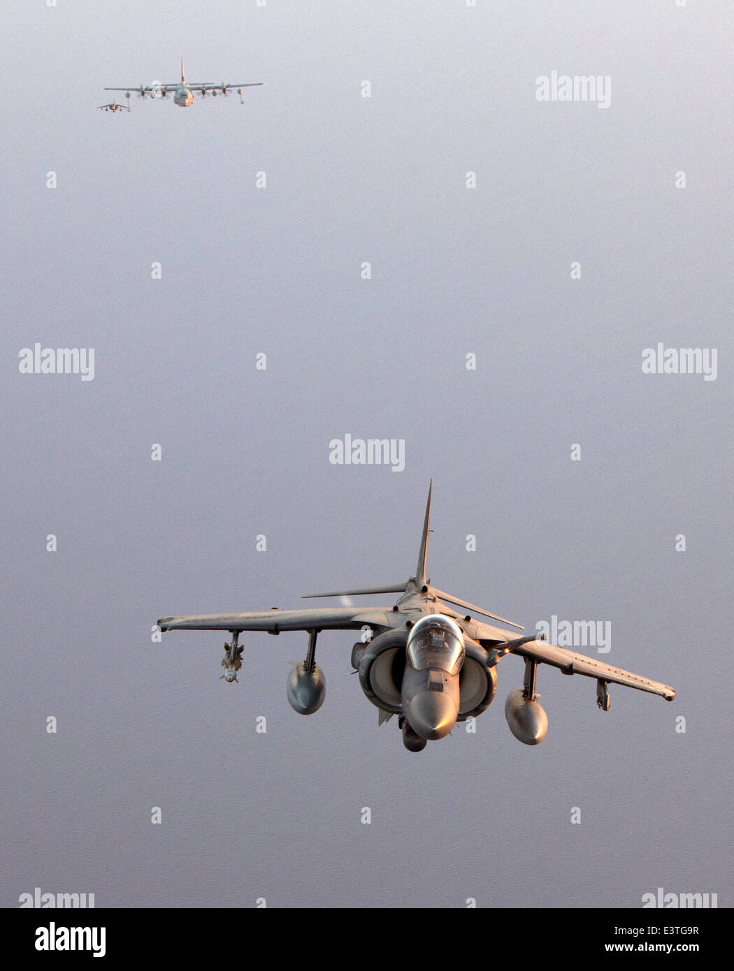 A US Marine Corps AV-8B Harrier II fighter aircraft flies over the ...