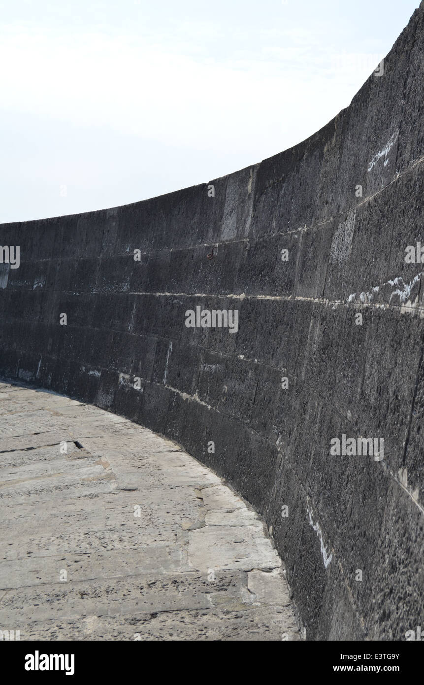 Stone sea wall defense at Lyme Regis England Stock Photo - Alamy