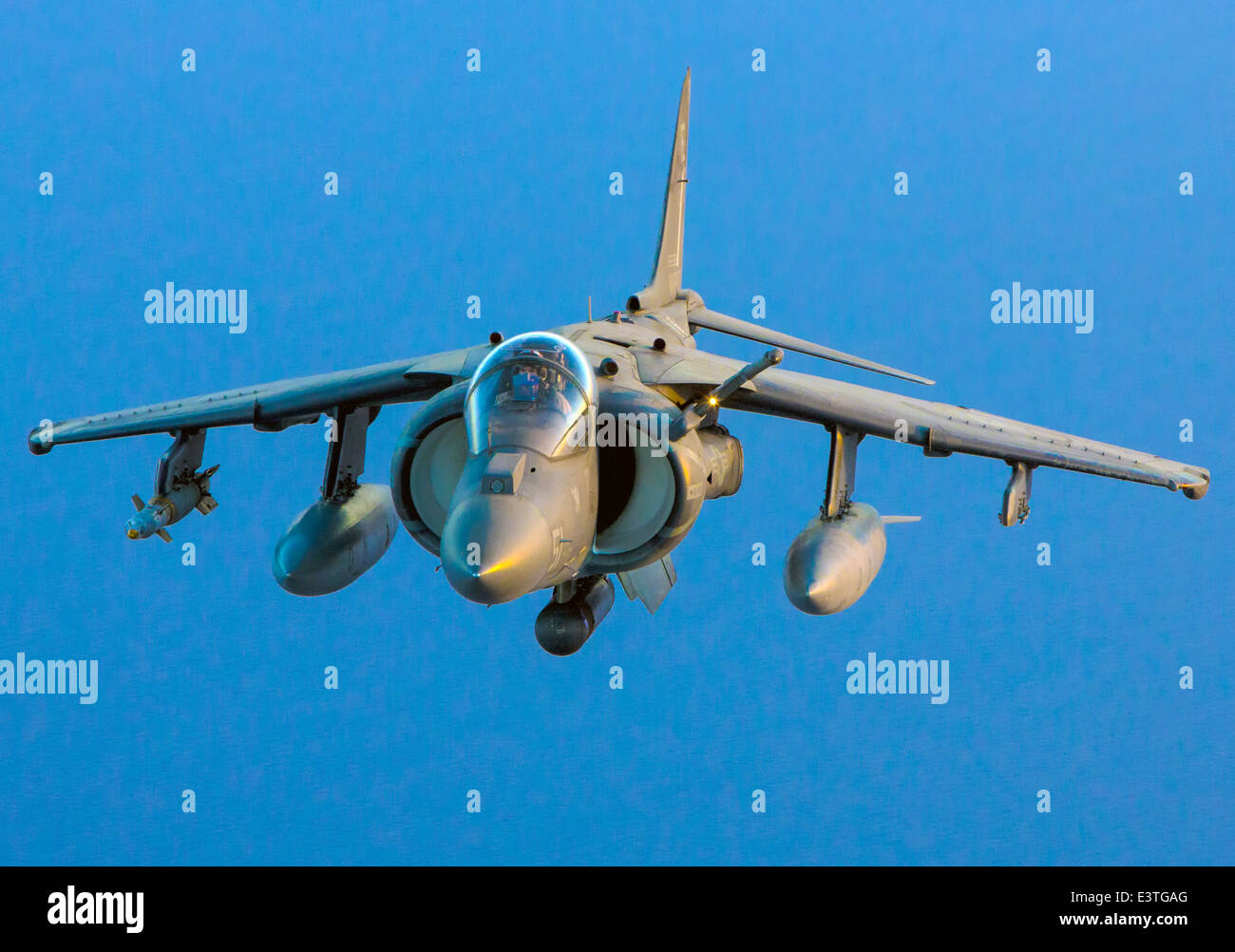 A US Marine Corps AV-8B Harrier II fighter aircraft flies over the ...