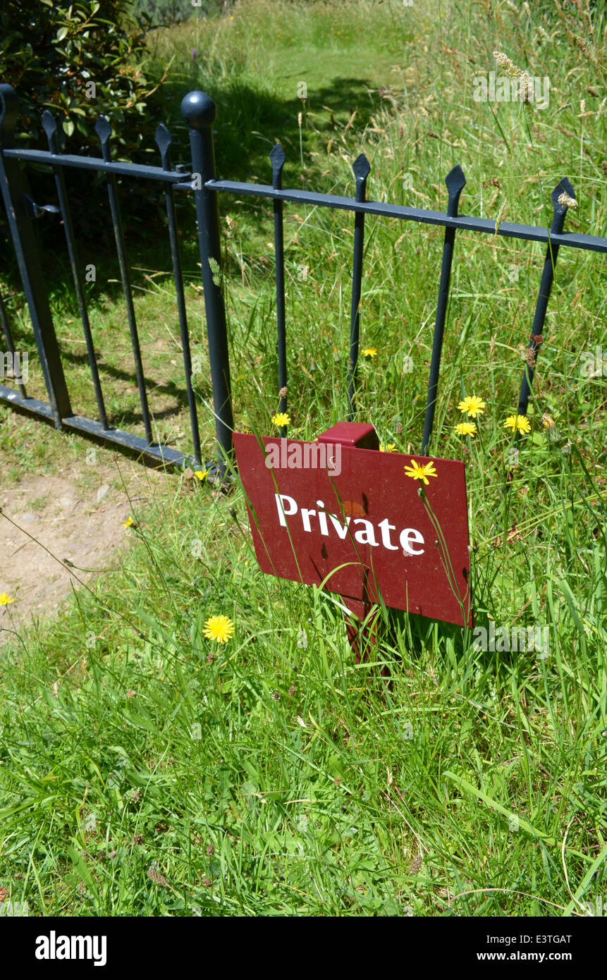 Private sign next to a ornate iron gate and fence Stock Photo - Alamy