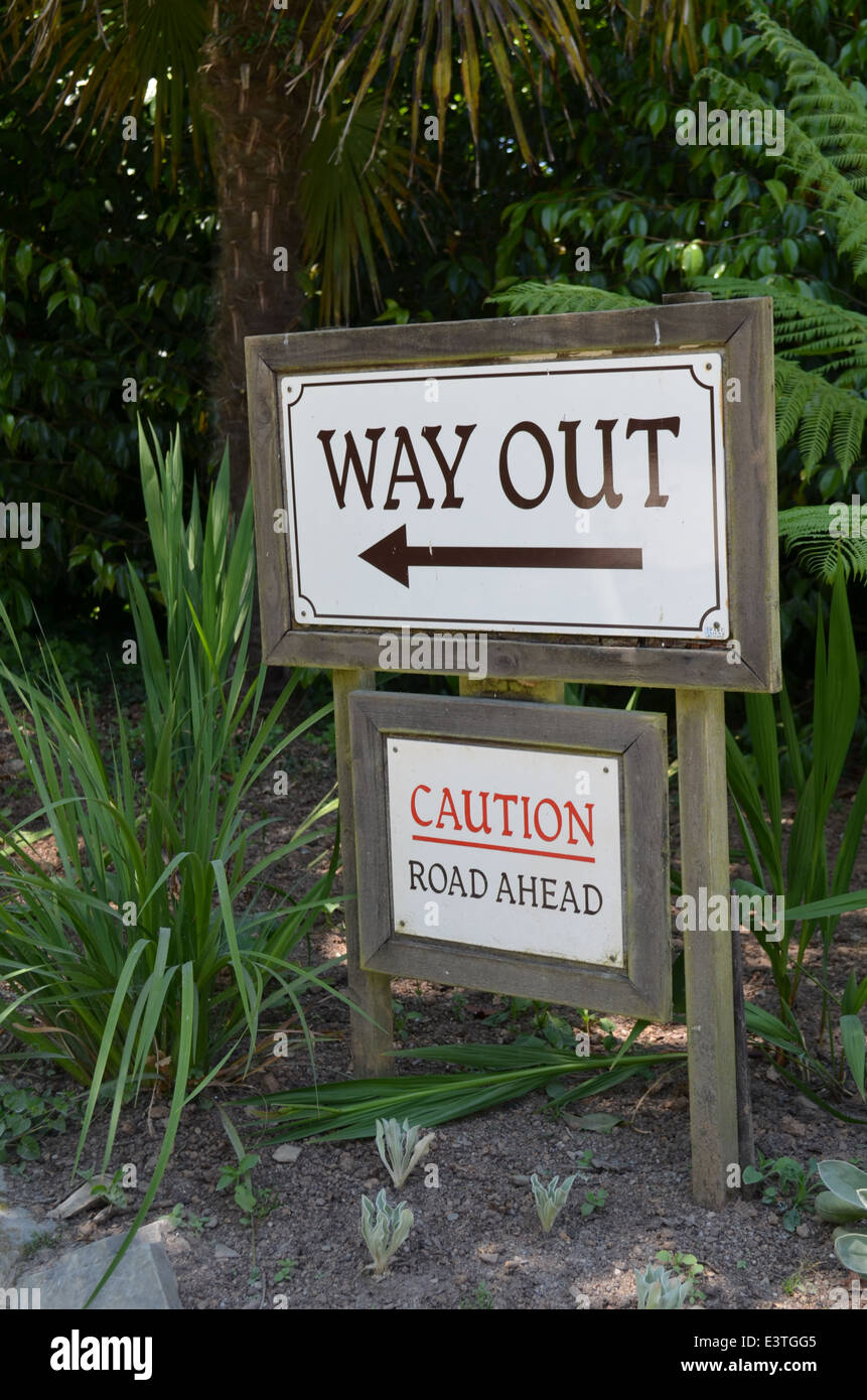 Way out sign and caution road ahead notice Stock Photo - Alamy