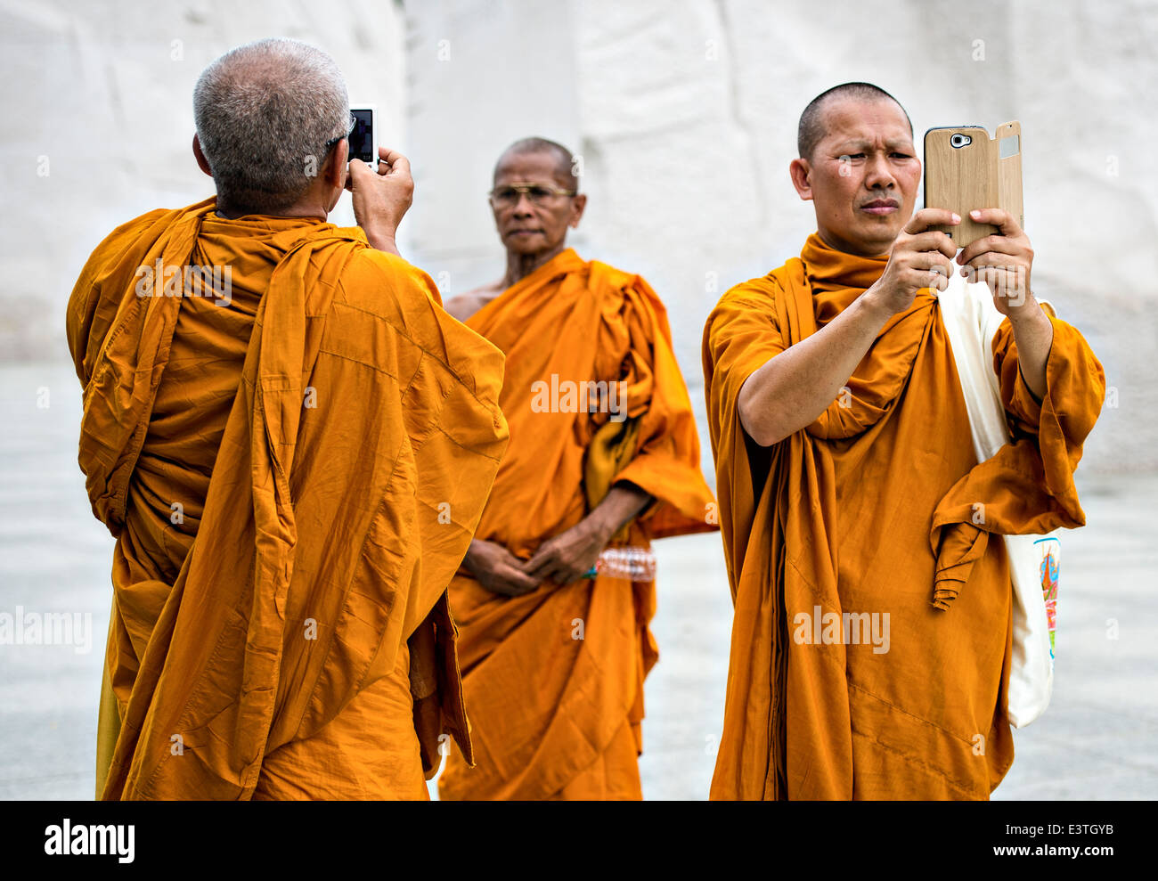 Thai Buddhist monks take camera phone photos of their visit to the ...