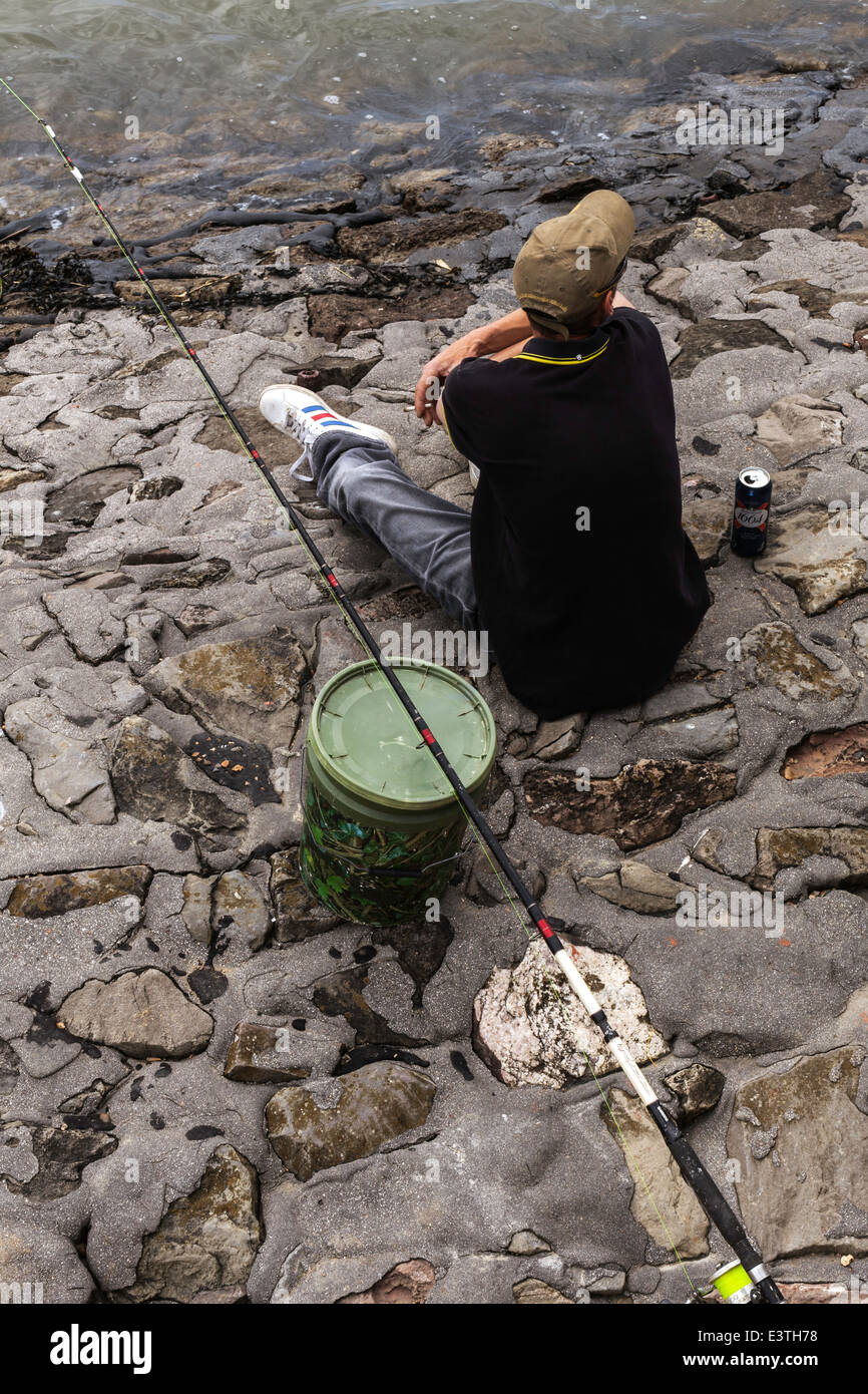 Lone Sea Angler with Cigarette & Can of Beer Stock Photo - Alamy