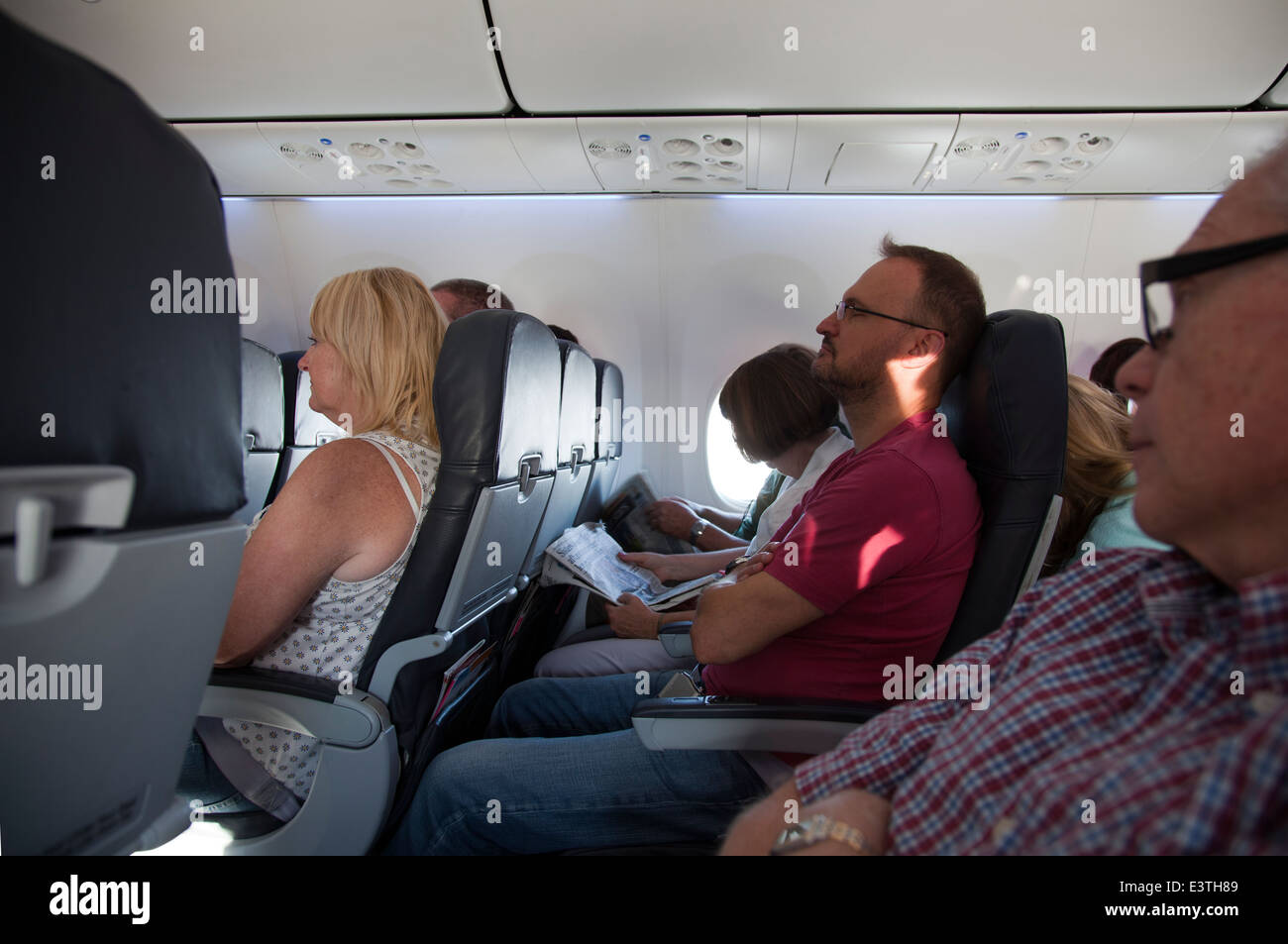 Passengers Seated onboard Thomson Charter Plane - UK Stock Photo - Alamy