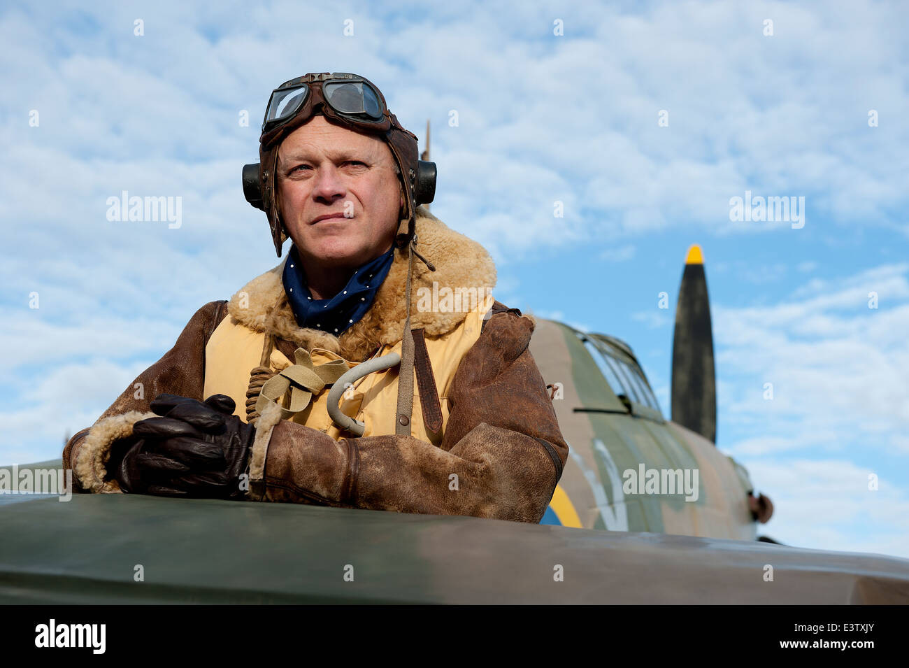 Low angle view of a World War Two RAF pilot resting next to his ...