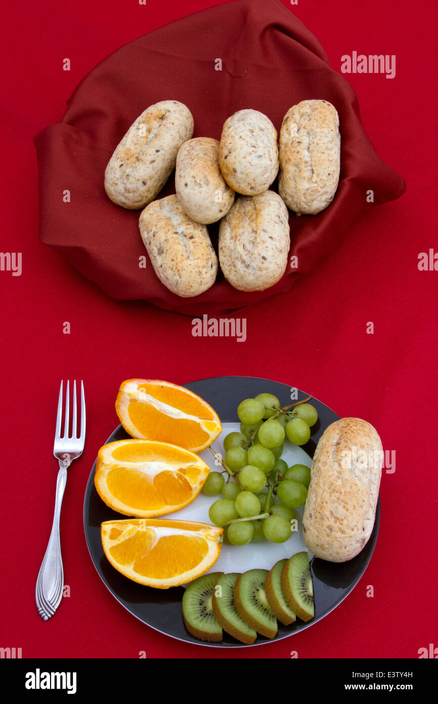 Breakfast setting of bread, oranges and kiwi fruit Stock Photo - Alamy