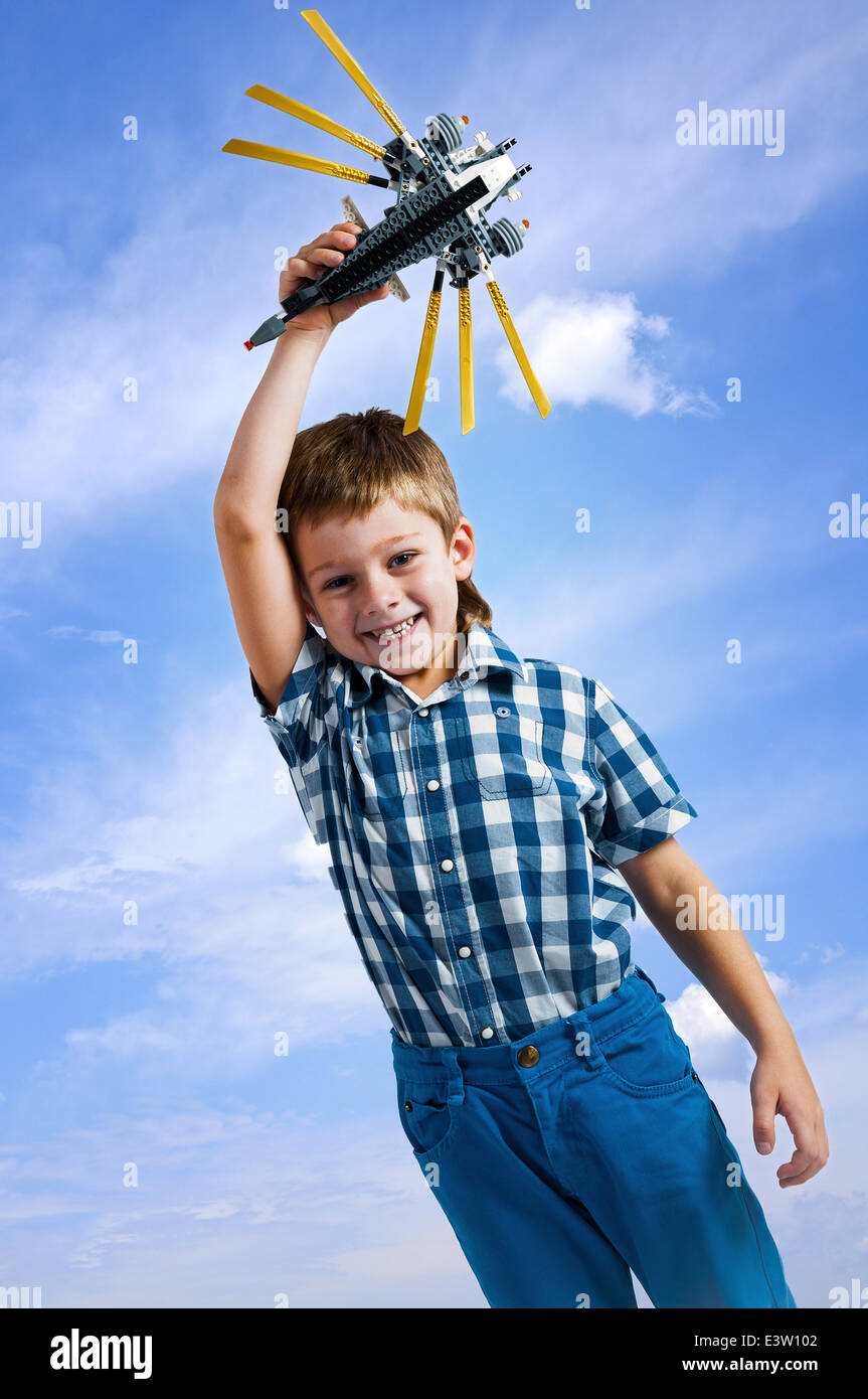 Young boy with helicopter toy on sky background Stock Photo - Alamy