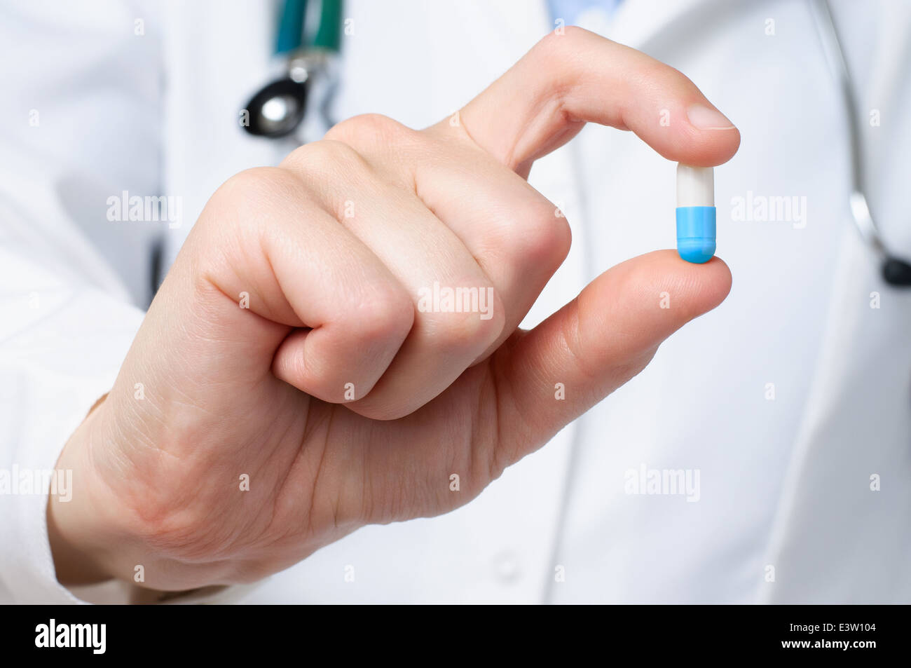 Doctor showing a blue pill Stock Photo - Alamy