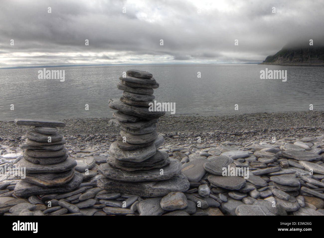 Stack of stones on northern Norway fjord background Stock Photo - Alamy