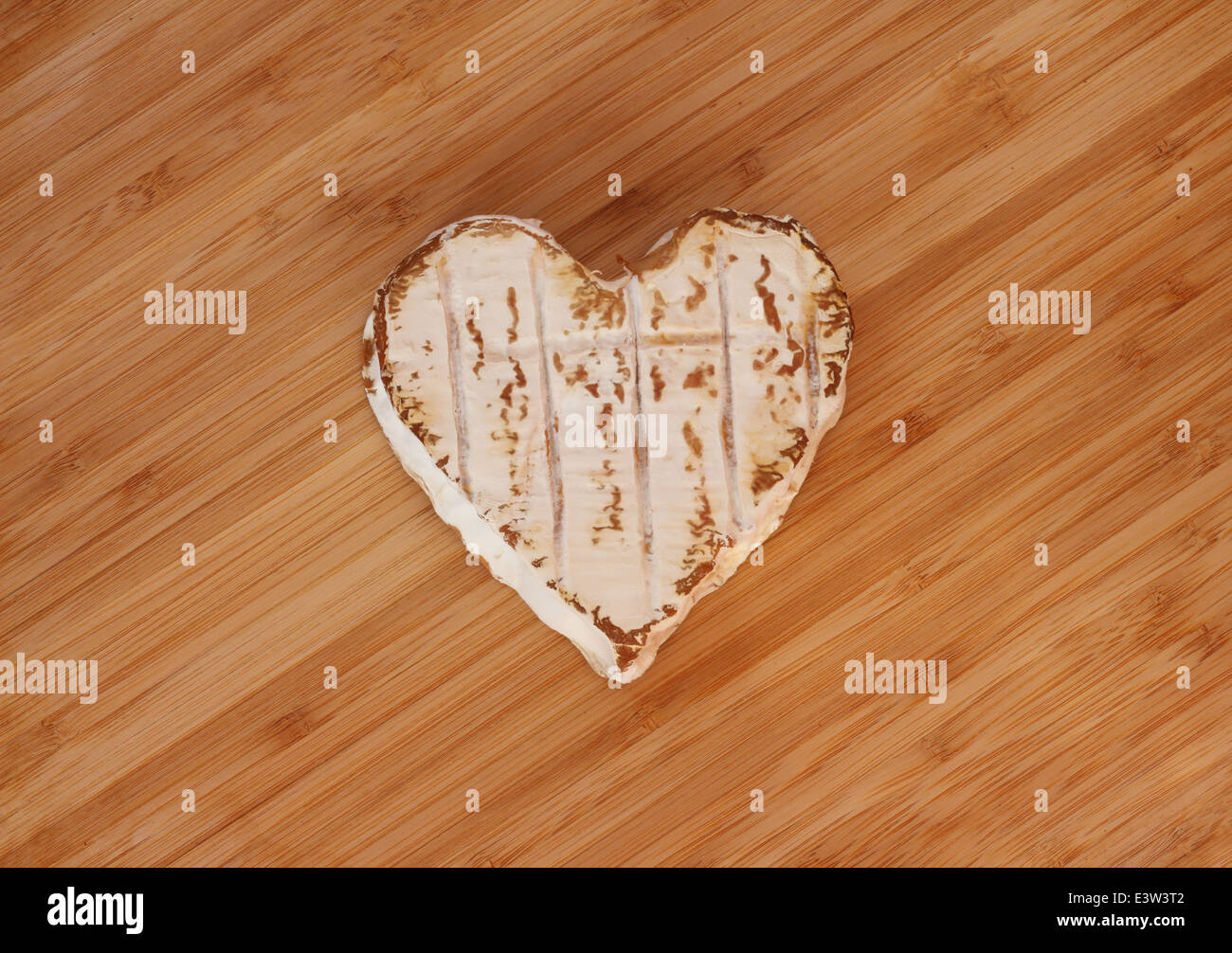 Neufchatel cheese shaped like heart on wooden cutting board Stock Photo ...
