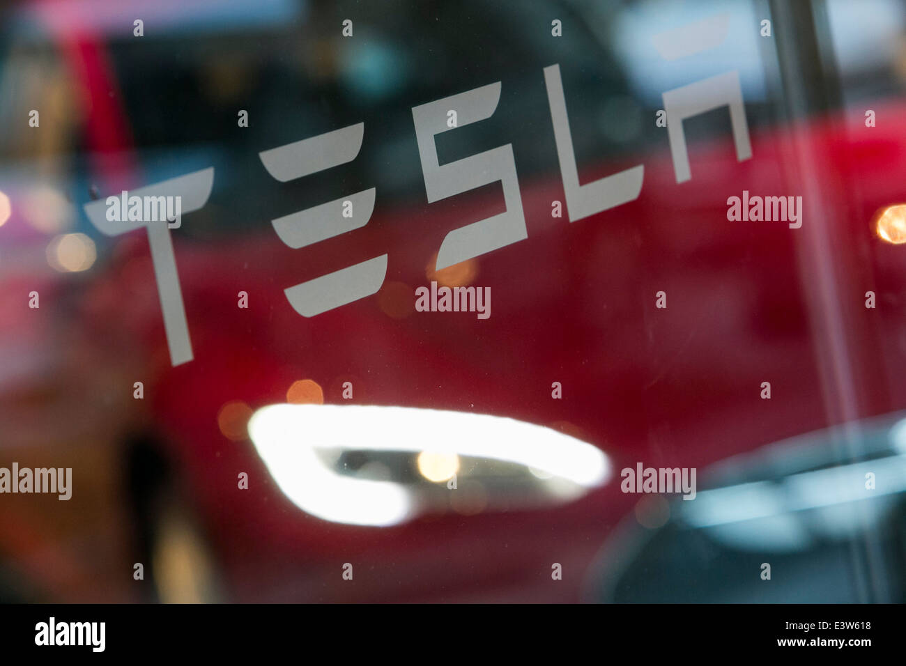 A Tesla Model S electric car is seen through the window of the downtown ...