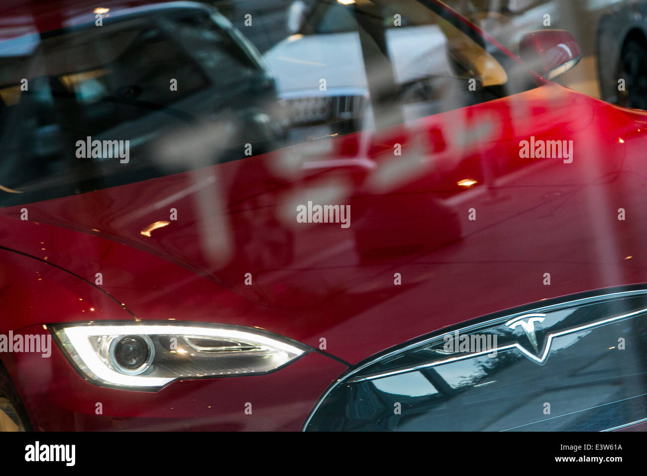 A Tesla Model S electric car is seen through the window of the downtown ...
