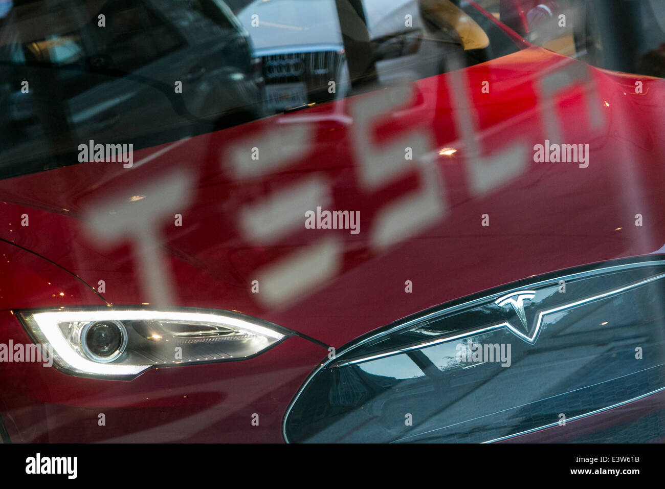 A Tesla Model S electric car is seen through the window of the downtown ...