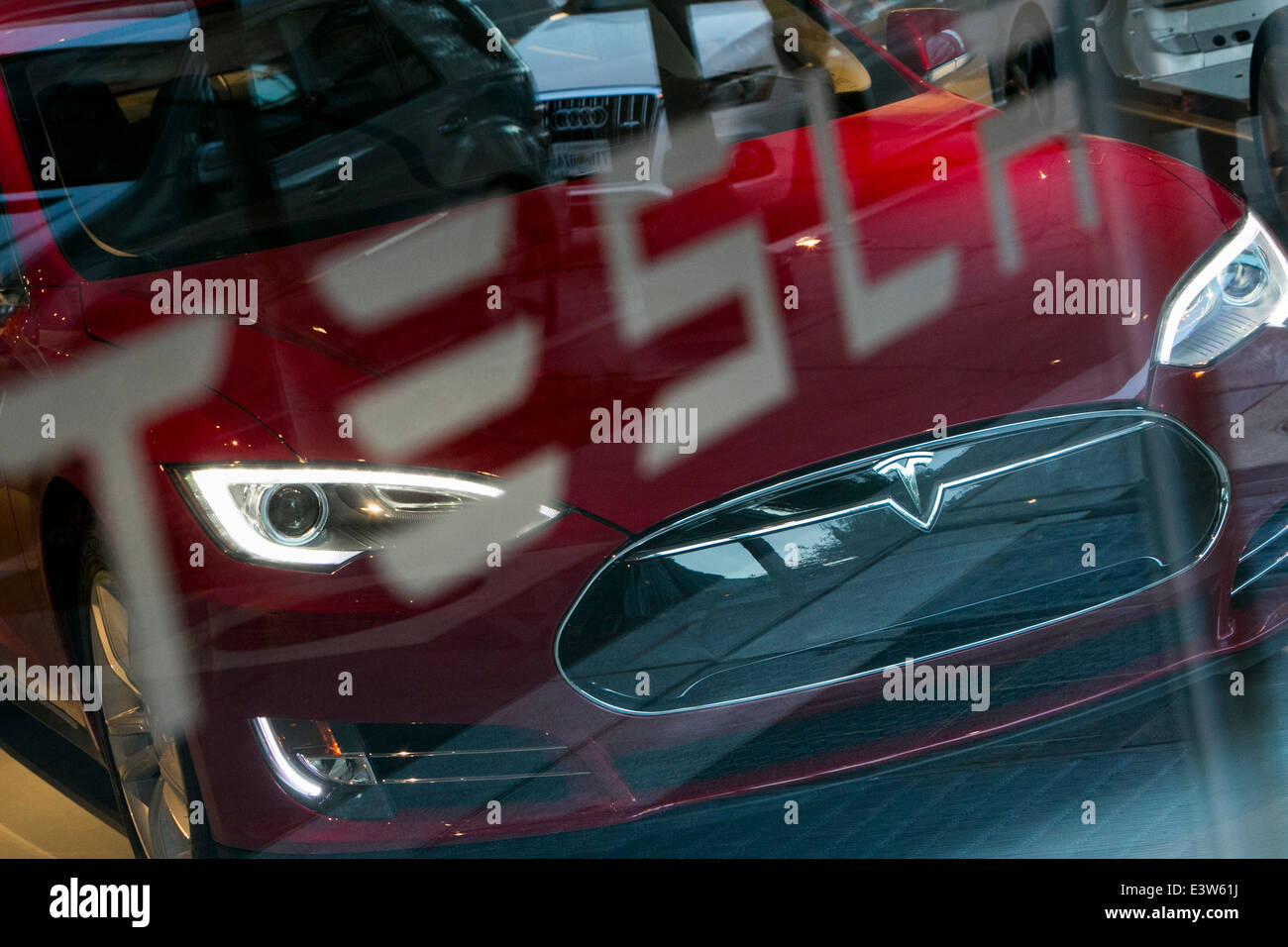 A Tesla Model S electric car is seen through the window of the downtown ...