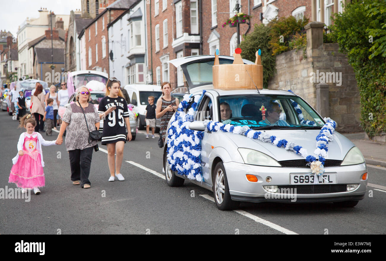 Car decorated with paper rosettes and crown carrying carnival kings ...