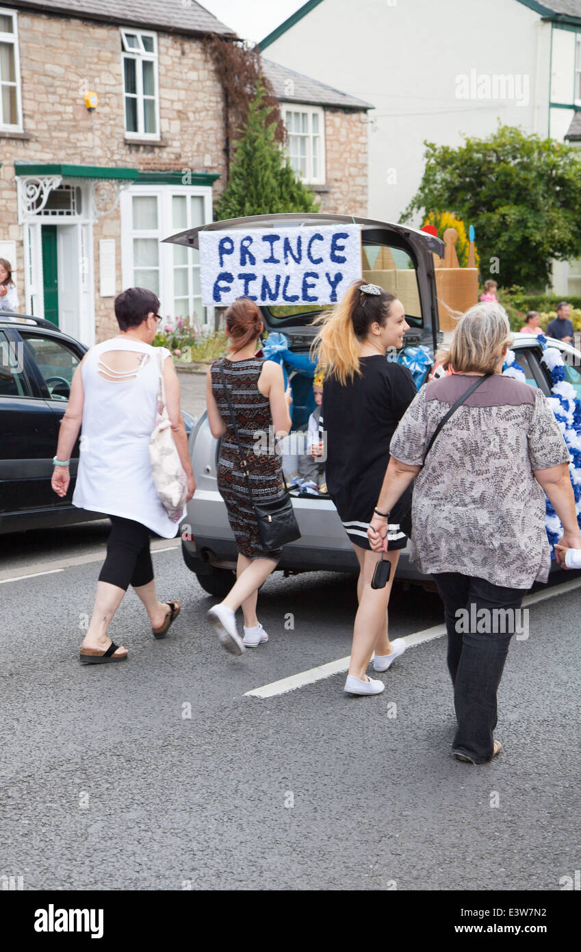 Car decorated with paper rosettes carrying carnival kings & queens as ...