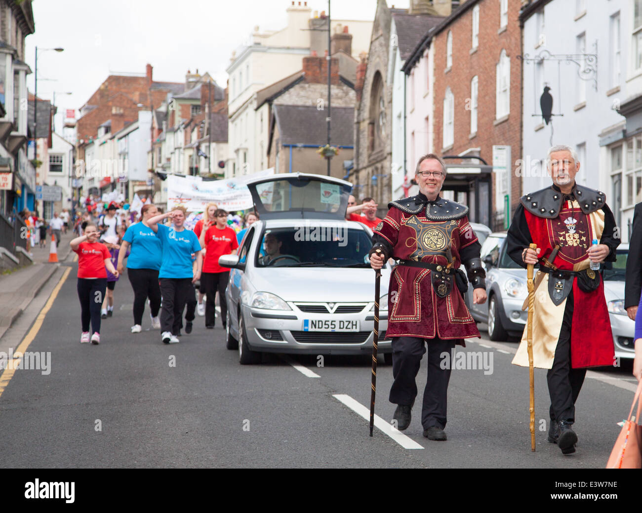 Two men in celtic dress / medieval costume and sticks walking down a ...