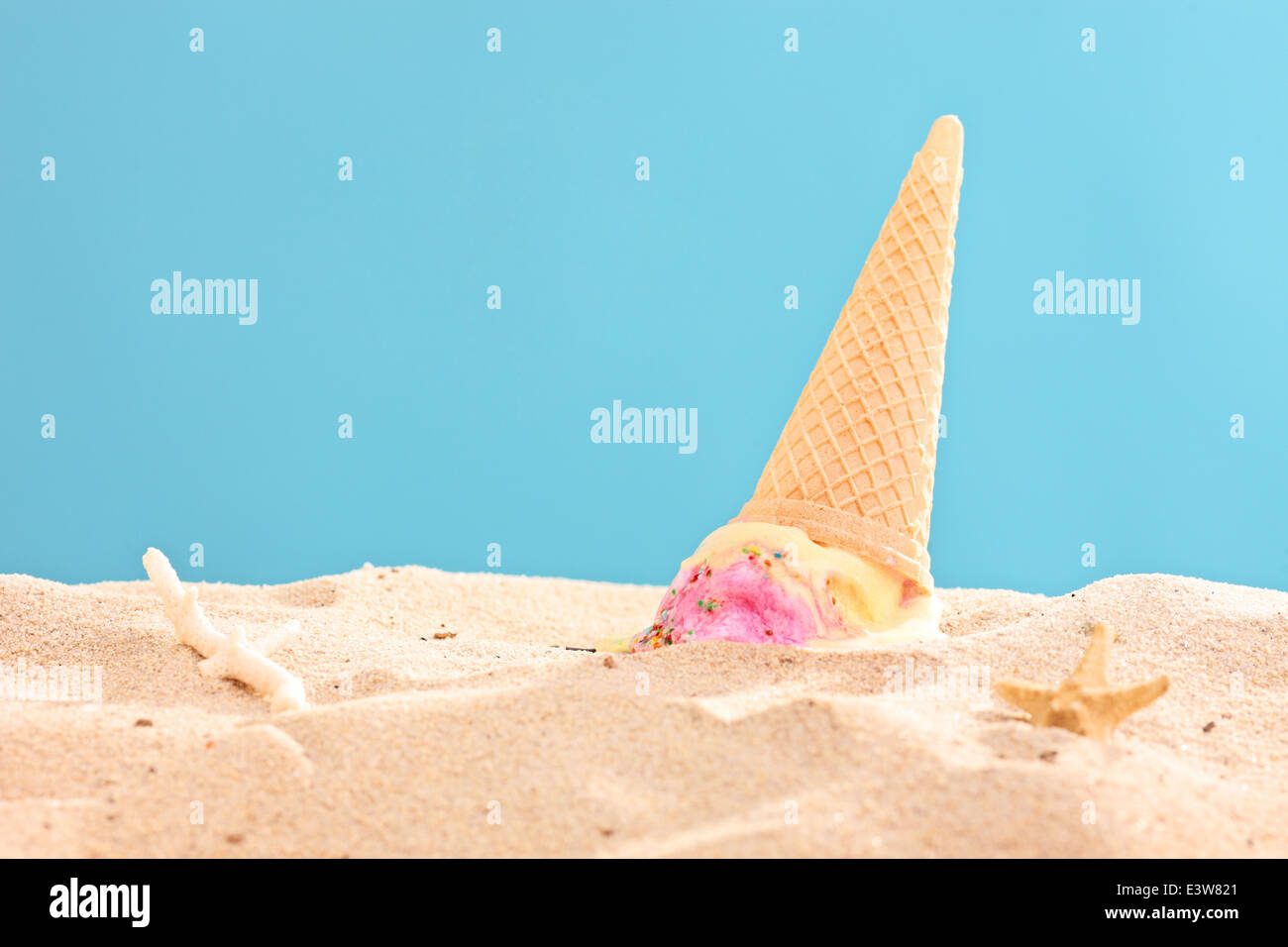 Studio shot of an ice cream splashed on sand Stock Photo - Alamy