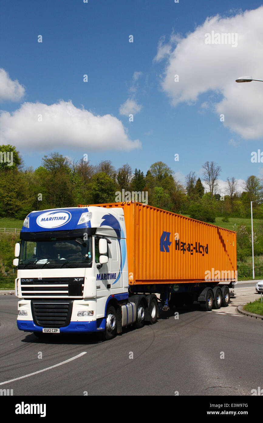 A Maritime truck hauling a Hapag Lloyd shipping container around a ...