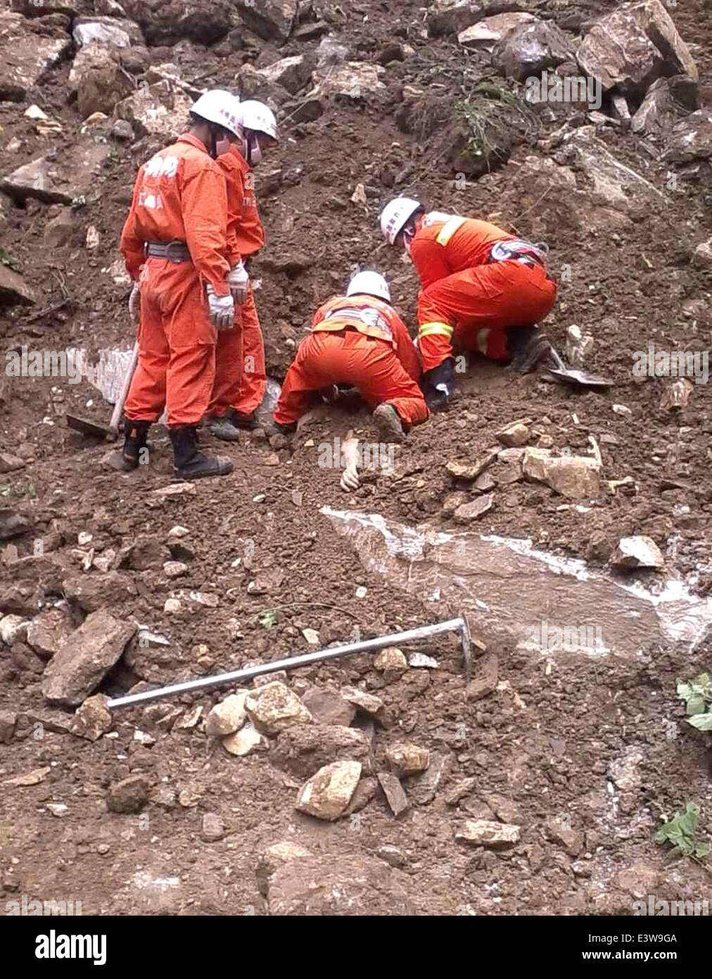 Fugong, Yunnan, China. 30th June, 2014. Rescuers work at a landslide ...